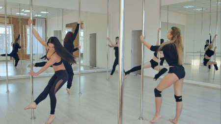 Group of hispanic women stretching and warming up for their pole dancing class - Stock Image ...