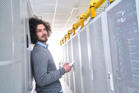 Young technician working in white server room - Stock Image - Everypixel