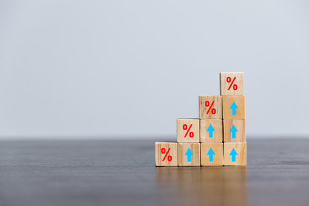 Closeup wood cubes with percentage symbol, Percent and upwards increasing arrows on wooden cubes ...
