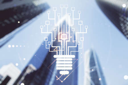 Virtual creative light bulb with chip hologram on blurry cityscape background, artificial ...