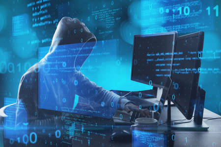Hacker at desktop using computer with abstract glowing blue coding background. Binary code ...