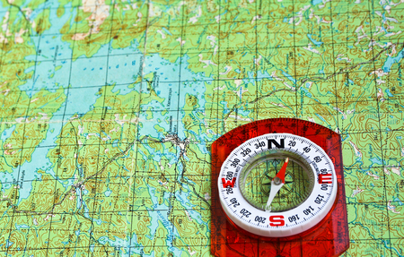 The magnetic compass and topographic map. Travel compass and map ...