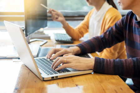 Programmer programming and coding software designer working on project in IT company office ...