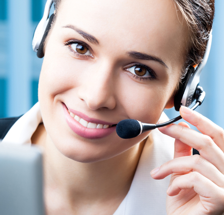 Portrait of happy smiling cheerful support phone operator in headset at office. Call center and ...