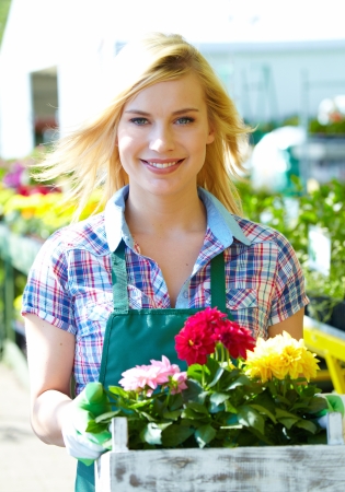 Florists woman working with flowers at a greenhouse - Stock Image - Everypixel