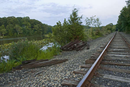 Old abandoned railroad tracks at dusk pass through Thompson Park, Monroe Township in Middlesex ...