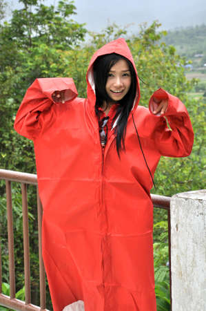Pretty woman in red raincoat on - Stock Image - Everypixel
