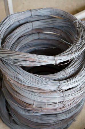 Close-up of stainless steel wire coils in warehouse - Stock Image ...