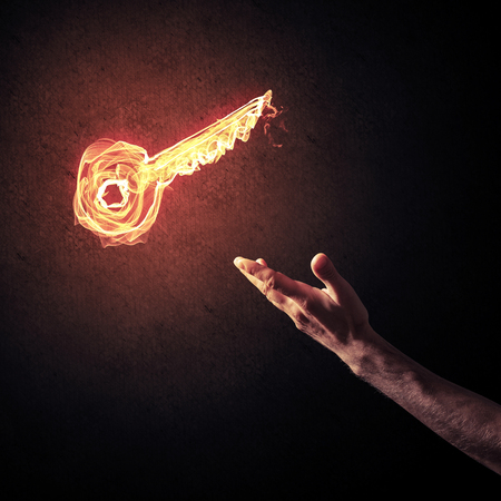Close of man hand showing on fire glowing key symbol - Stock Image ...