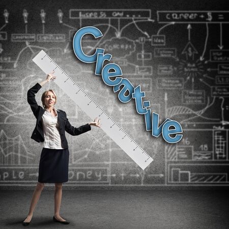 Woman holding big ruler on background chalkboard. Businesswoman ...