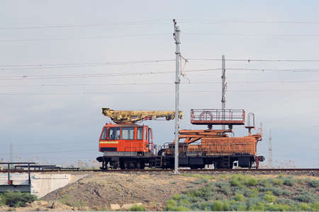 tie crane doing the railroad maintenance at train station. Crane for ...