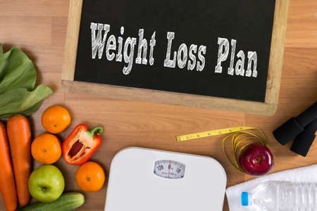 weight loss plan Fitness and weight loss concept, dumbbells, white ...