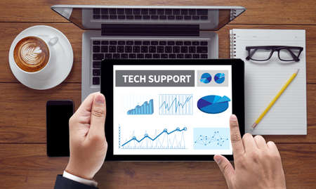 TECH SUPPORT, on the tablet pc screen held by businessman hands ...
