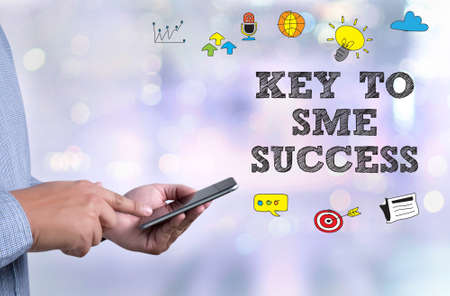 KEY TO SME SUCCESS Small and medium-sized enterprises person holding a ...