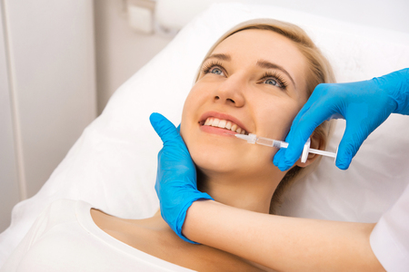 Beautiful woman gets beauty facial injections. Face aging injection ...