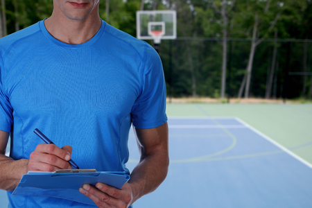 Basketball trainer with workout plan close up on basketball field. Team ...