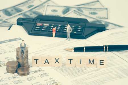 wording tax and miniature business toy with tax documents, money on ...