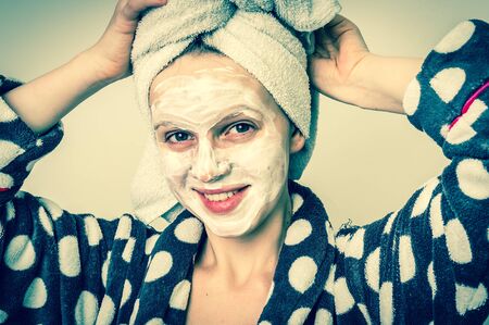 Attractive woman applying natural facial mask from sour cream - retro ...