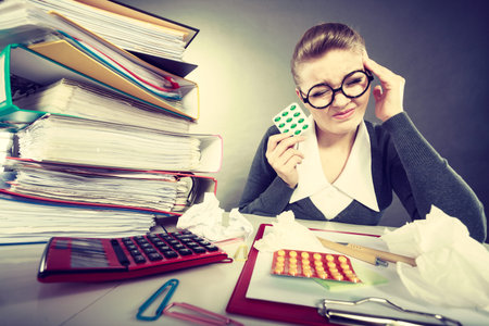 Fatigue and pain concept. Young elegant businesswoman with lot of pills ...