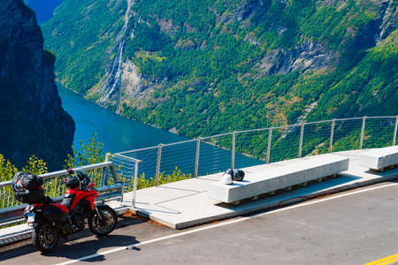 Motorbike at Ornesvingen view point. Geiranger fjord landscape ...