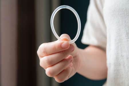 Womans hand holding a birth control ring, vaginal ring for ...