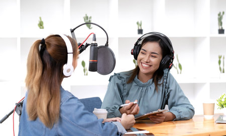 Smile two asian young woman, man radio hosts in headphones, microphone ...