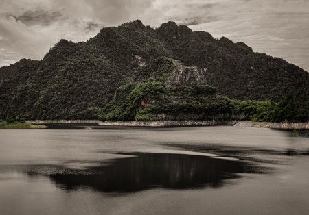 Natural scenery of water in reservoirs and dam with sky and mountains ...