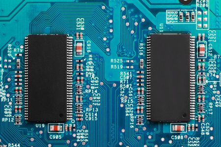 Power of technology: two chips on blue circuit board - Stock Image ...