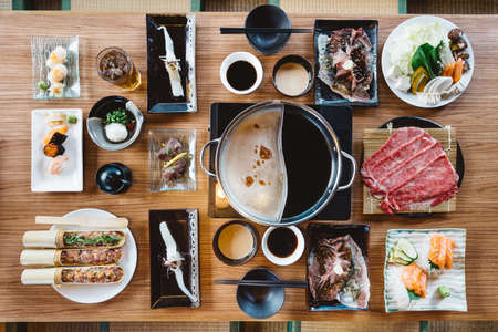 Top view of Shabu set including rare slices Wagyu A5 beef, Shabu shoyu ...