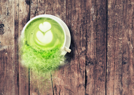 explosion of Green tea milk latte art in flower shape served in white ...