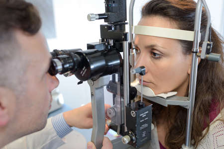 eye doctor druring a test with patient - Stock Image - Everypixel