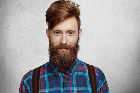 Portrait of handsome student with trendy beard and mustache dressed in ...