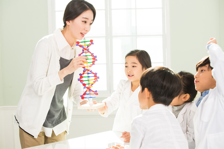 Young Students Learning About DNA With A Female Teacher - Stock Image ...