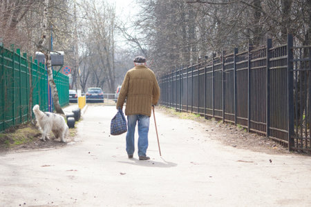 Pensioner in Russia. Grandpa walks down street. Old man with support ...