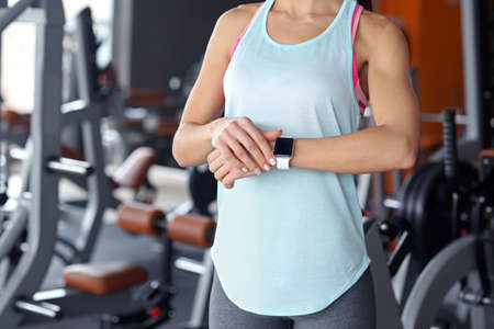 Young woman with fitness tracker in gym - Stock Image - Everypixel
