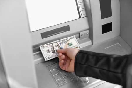 Man taking money from cash machine outdoors, closeup view - Stock Image ...