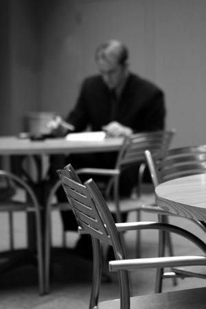 Businessman sitting down at table crunching the numbersの写真素材 ...
