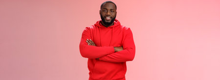 Attractive bearded african-american young guy wearing red hoodie cross ...
