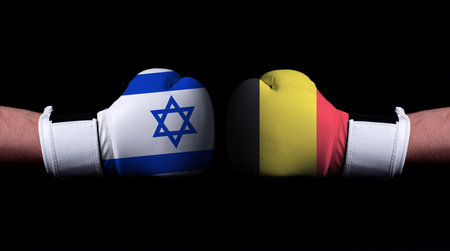 Two hands of wearing boxing gloves with Belgium and Israel flag. Boxing ...