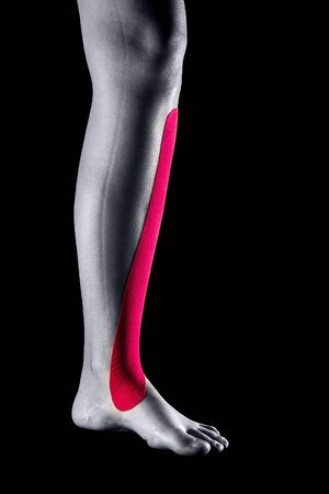 Medical taping for leg pain relief showed on young model. - Stock Image ...