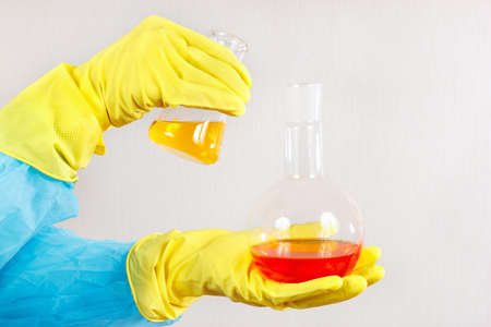 Hands of scientist in rubber gloves doing chemical research in the ...