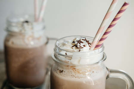 Hot Cocoa drink with milk in retro glass jar (Mason Jar), pink straw on ...