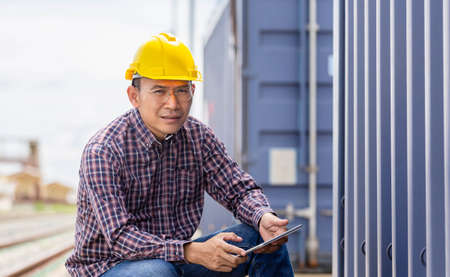Relaxing engineer man in industry containers cargo, Foreman dock worker ...
