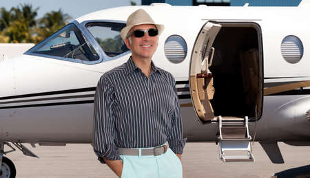 Handsome man standing outside a private jet - Stock Image - Everypixel