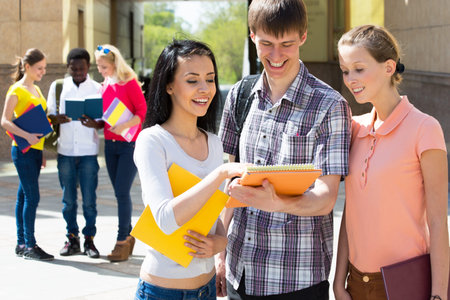 Group of university students studying reviewing homework - Stock Image ...