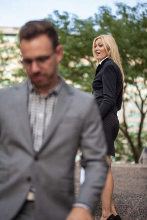 Woman showing power over man in business setting outdoors - Stock Image ...