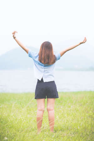 Young woman standing at relax pose or freedom pose or chill pose on the ...