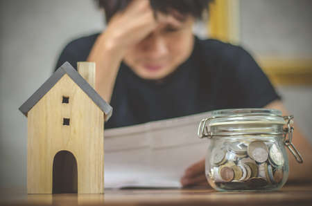 Young man checking bills and having financial problems with home debt ...