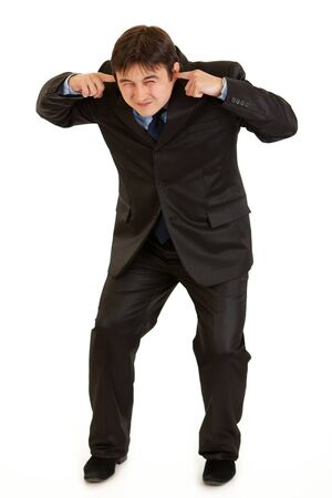 Businessman ducking in fear and closing ears with fingers isolated on ...