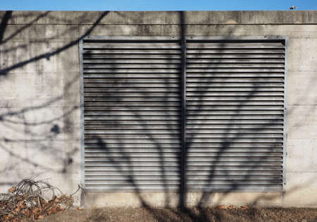 Air vent in concrete wall with tree shadow and blue sky - Stock Image ...